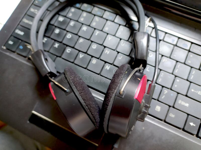 A Headphone Cable on a Black Laptop on a Table Stock Photo - Image of ...