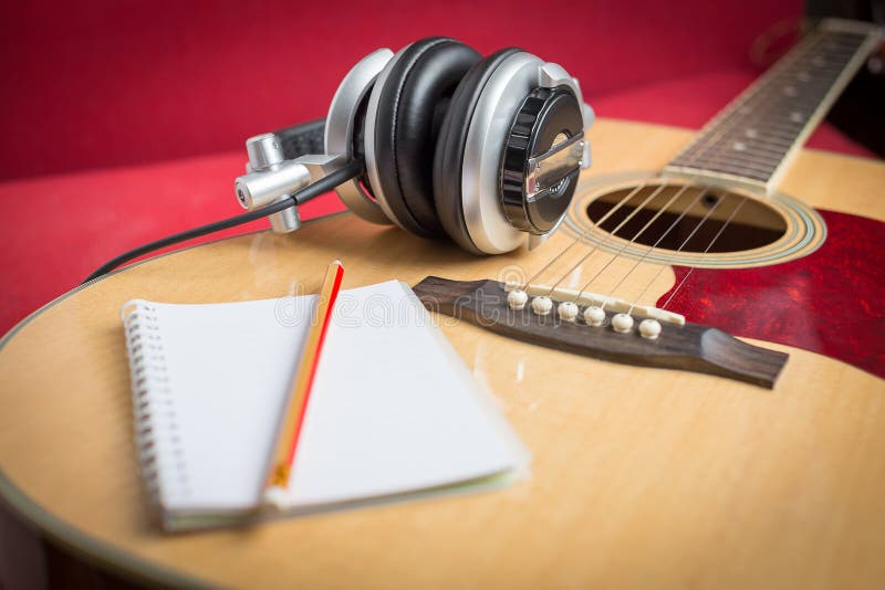 Headphone and Notebook and Pencil on Guitar Stock Image - Image of ...