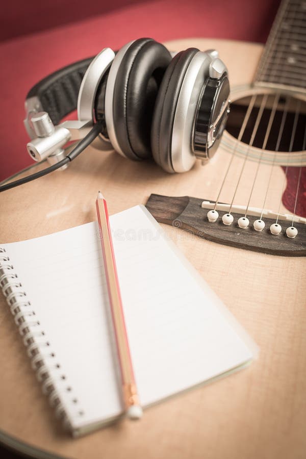 Headphone and Notebook and Pencil on Guitar Stock Image - Image of ...