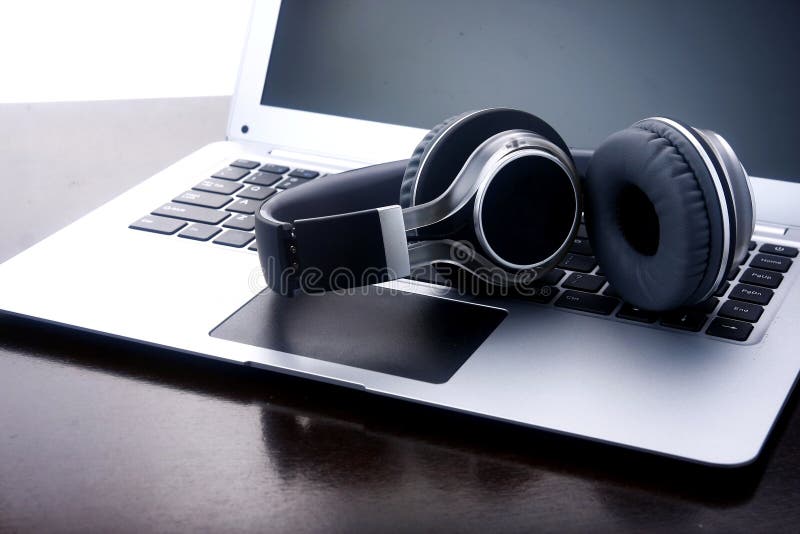 Headphones on a Laptop Computer. Stock Photo - Image of earphones ...