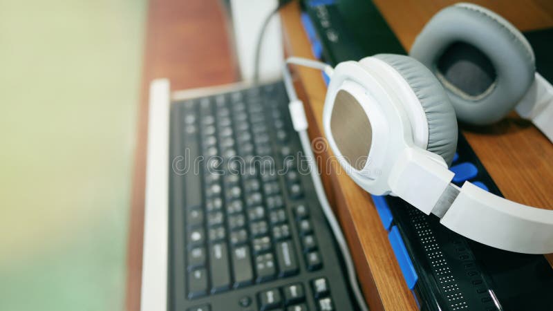 Headphones on Refreshable Braille Display and Computer Keyboard on the ...