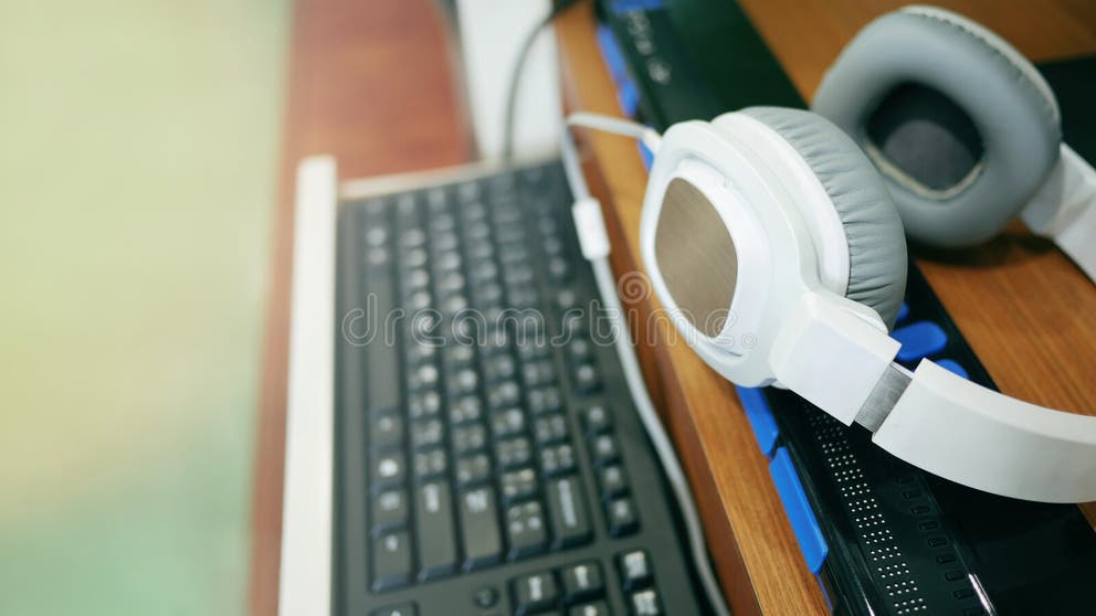Headphones on Refreshable Braille Display and Computer Keyboard on the ...