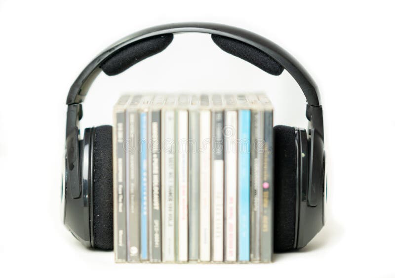 Headphones on Stack of Cds Listening To Music Concept Stock Image ...