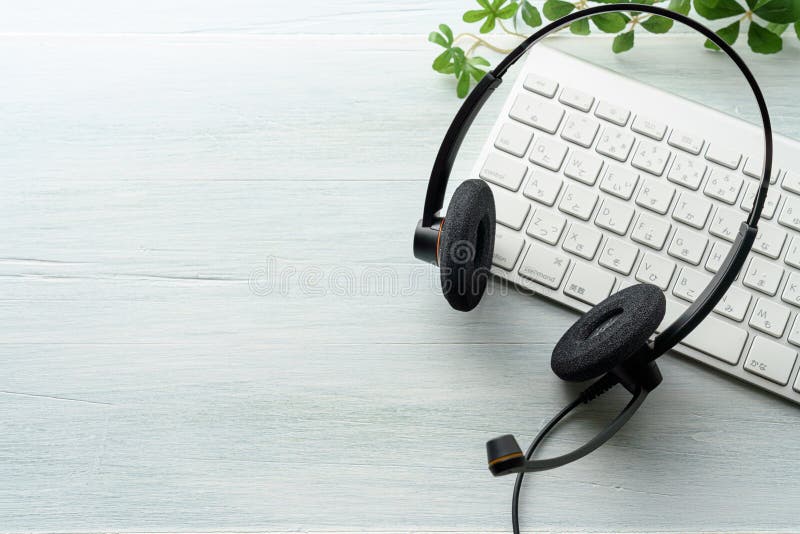 Headset and Computer Keyboard on Wooden Table Stock Photo - Image of ...