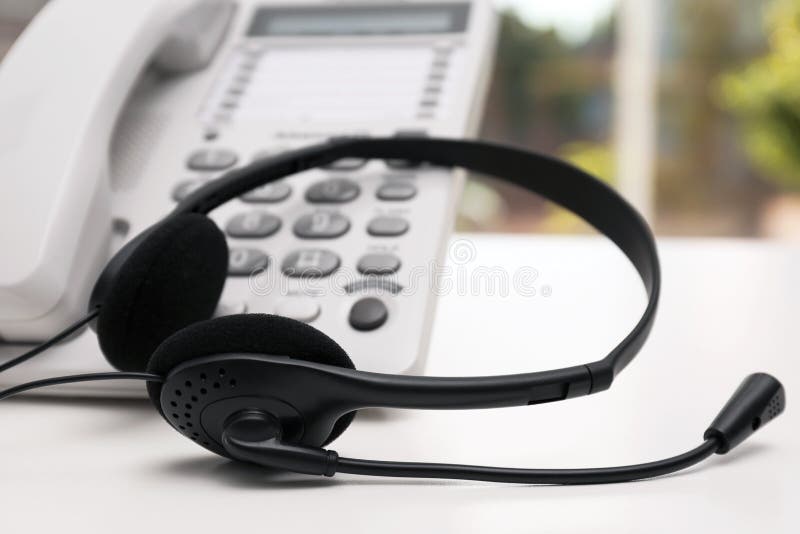 Headset and Desk Phone on Table Indoors. Stock Image - Image of line ...
