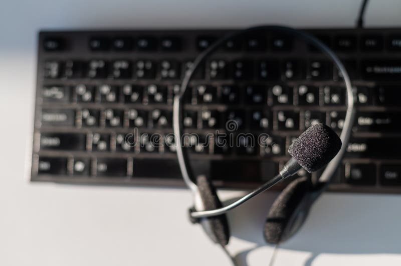 Headset with Microphone on the Computer Keyboard. Call Center Operator ...