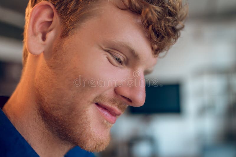 Headshot of a Ginger Young Man Looking Down and Smiling Stock Image ...