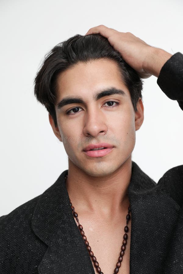 Headshot of Young Handsome Man Touching Hair Posing Over White ... Headshot of Young Handsome Man Touching Hair Posing Over White ...