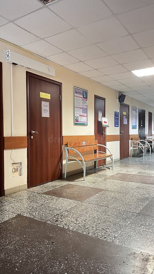 Health Facility Corridor Featuring Multiple Closed Doors and Seating ...