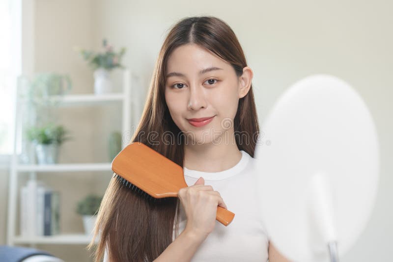 Health Hair Care Beauty Makeup Asian Woman Girl Holding Hairbrush And Brushing Combing Her