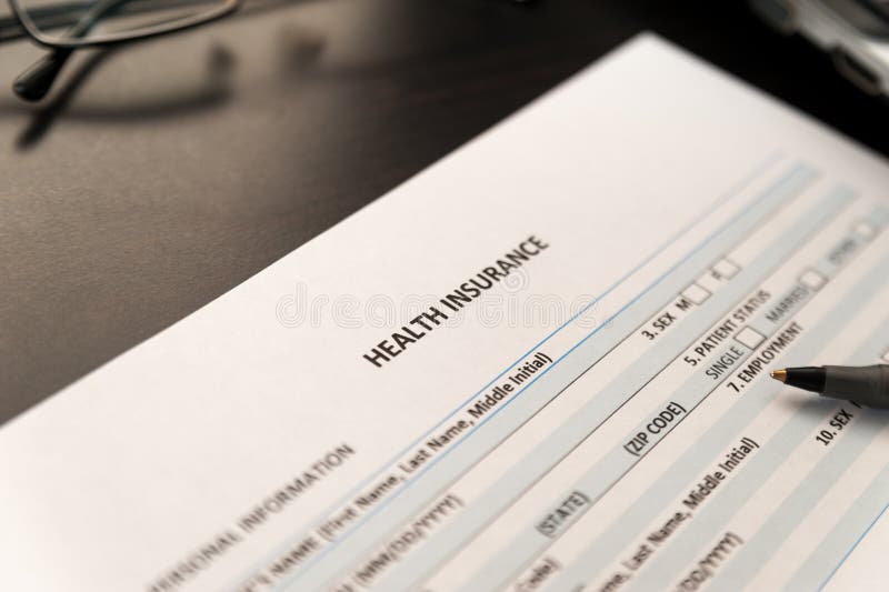 Health Insurance Application Form on a Wooden Table Stock Photo - Image ...