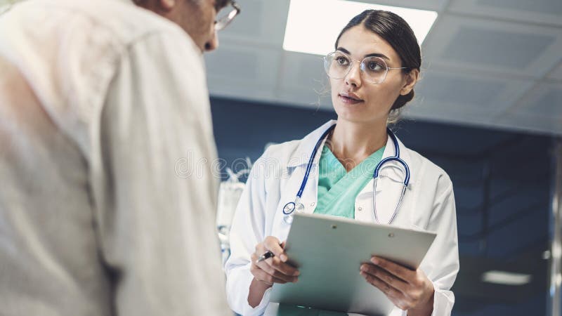 Health Worker Taking Notes from Male Patient Stock Image - Image of ...