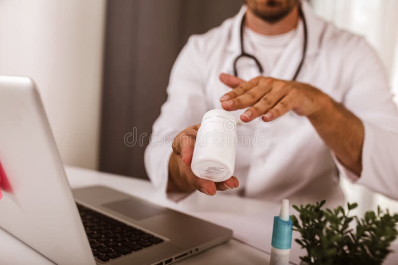 General Practitioner Using Computer Laptop Explaining How To Use the ...