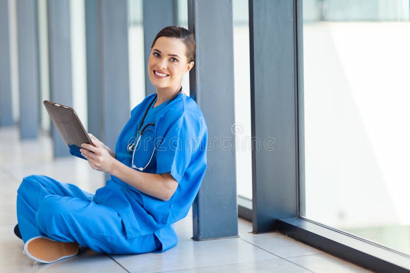 A Nurse Sitting at a Computer Stock Photo - Image of scrubs, confidence ...