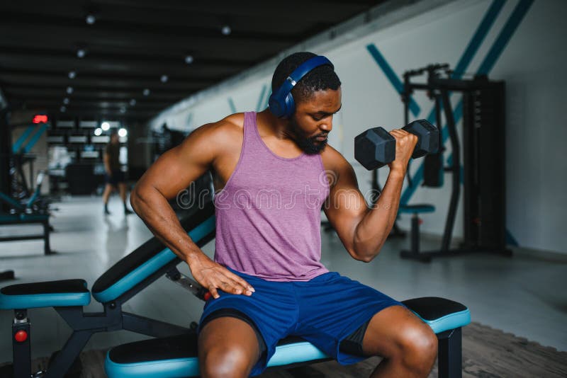 Healthy African Man Working Out with Dumbbells in Gym. Stock Photo ...
