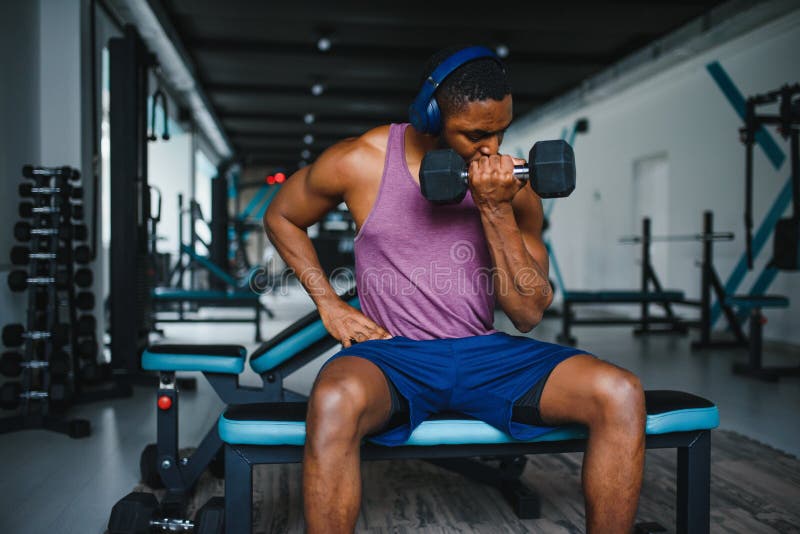 Healthy African Man Working Out with Dumbbells in Gym. Stock Photo ...