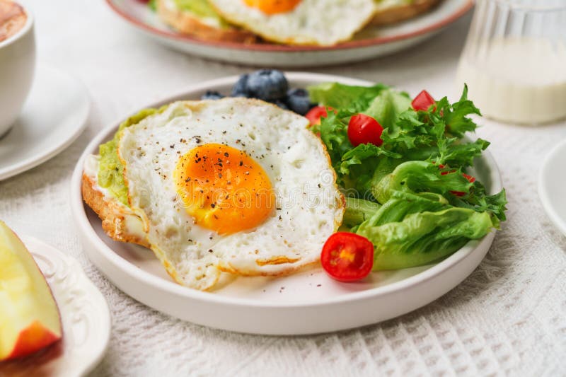 Healthy Breakfast Bread Avocado Fried Egg and Salad Stock Photo - Image ...
