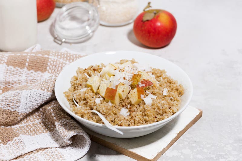 Healthy Breakfast Quinoa with Apple and Coconut on White Table Stock ...
