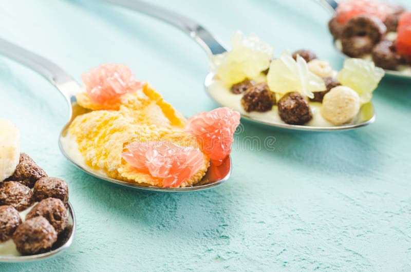 Healthy Breakfast. Yogurt, Flakes and Fruit in Spoons on a Blue ...