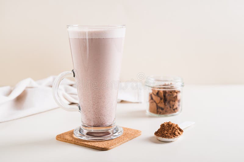 Healthy Chocolate Protein Drink in a Glass and Powder in a Jar on the ...