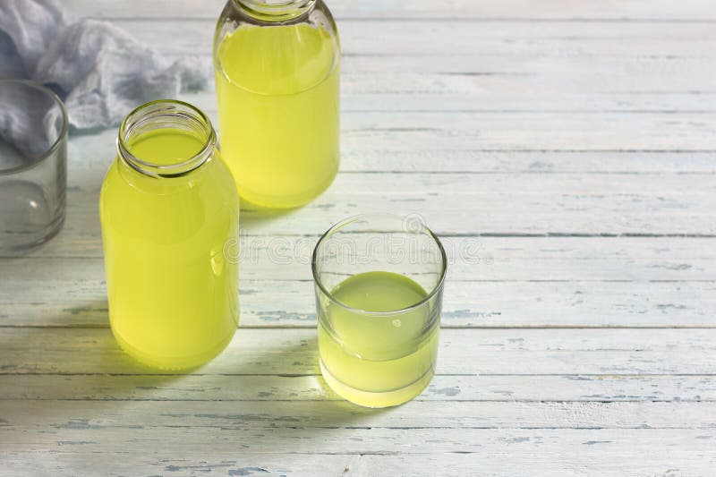 Healthy Dietary Milk Whey in Glass and Bottle on Light Blue Table Stock ...