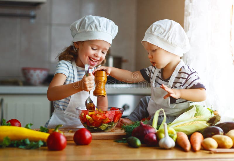 Healthy Eating. Happy Children Prepares Vegetable Salad in Kitc Stock ...