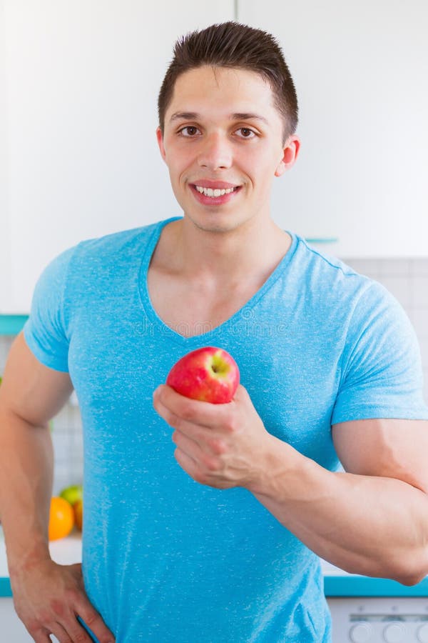 Healthy Eating Young Man Eat Apple Fruit in the Kitchen Portrait Stock ...