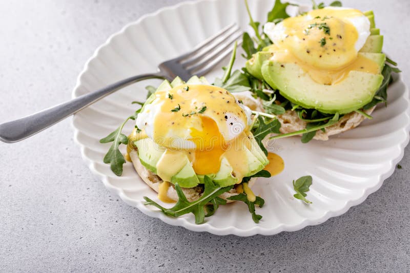Healthy Egg Benedict with Avocado and Arugula Stock Photo - Image of ...