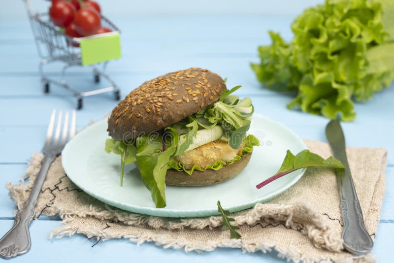 Healthy Fish Burger with Arugula on Blue Background Stock Photo - Image ...