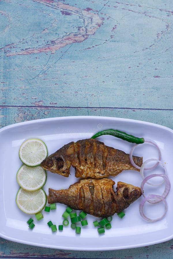 Healthy Fish Fry with Lemon, Onion and Chilli Top View with Space Stock ...