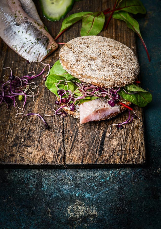 Healthy Fish Sandwich with Grain Bread and Fish on Rustic Cutting Board ...