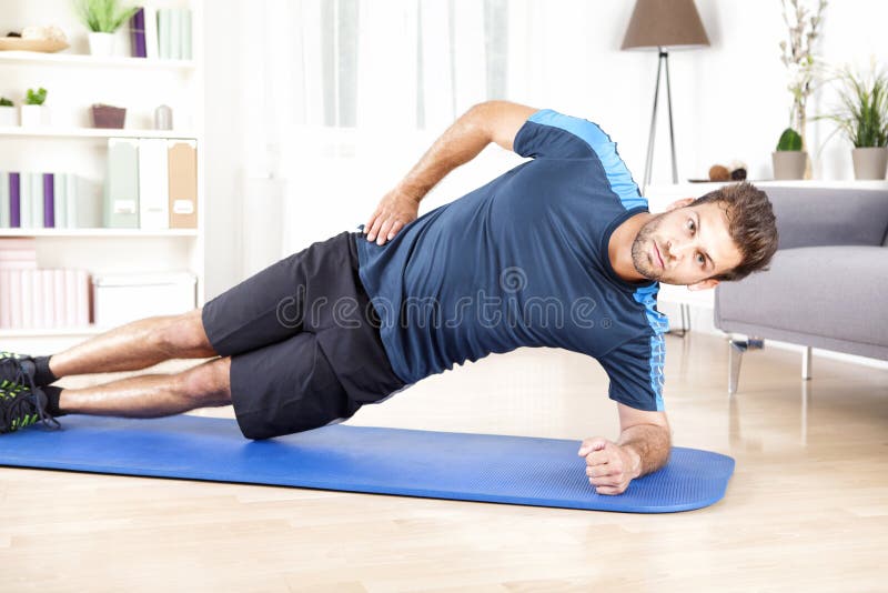Healthy Man Doing Side Plank Exercise on a Mat Stock Photo - Image of ...