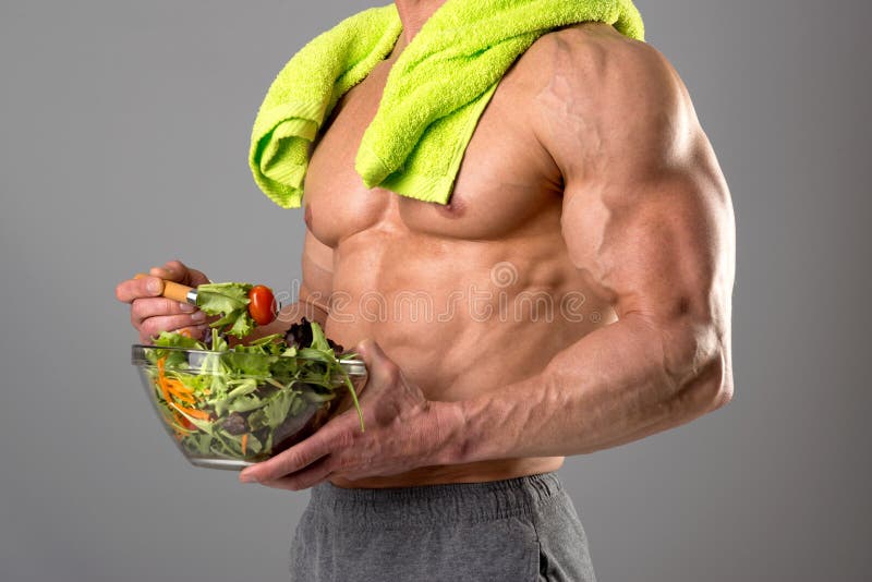 Healthy man eating a salad stock photo. Image of bodybuilder - 91373168
