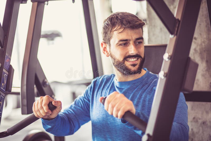 Healthy Man on Exercise Machine. Stock Photo - Image of exercising ...