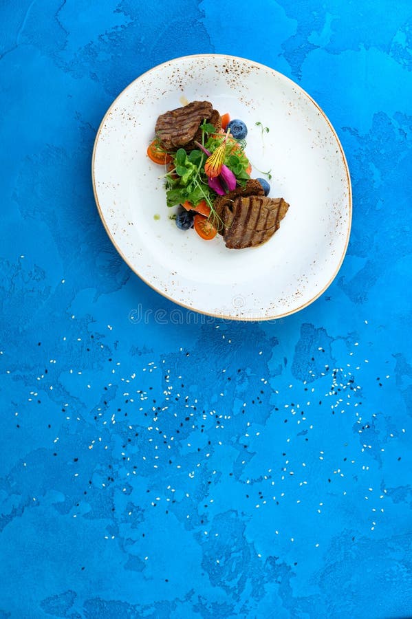 Meat for a Dinner on a Blue Background Stock Image - Image of herbs ...