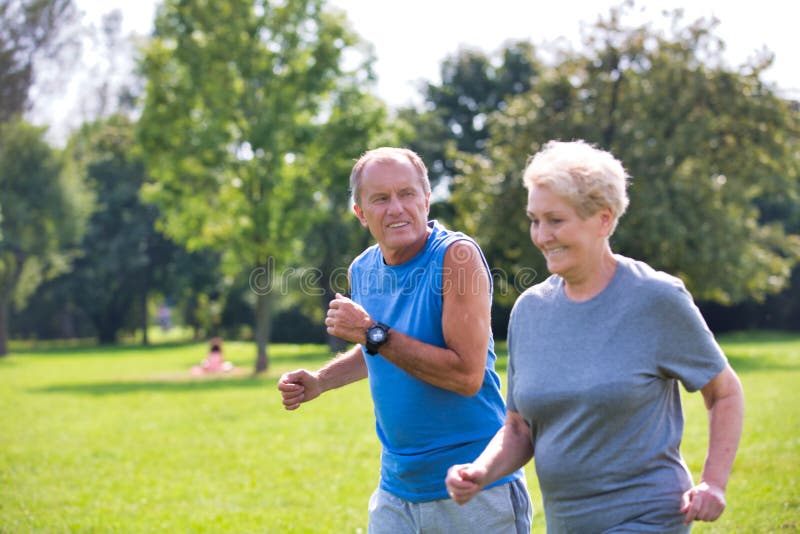 Healthy Senior Couple Jogging in Park Stock Image - Image of park ...