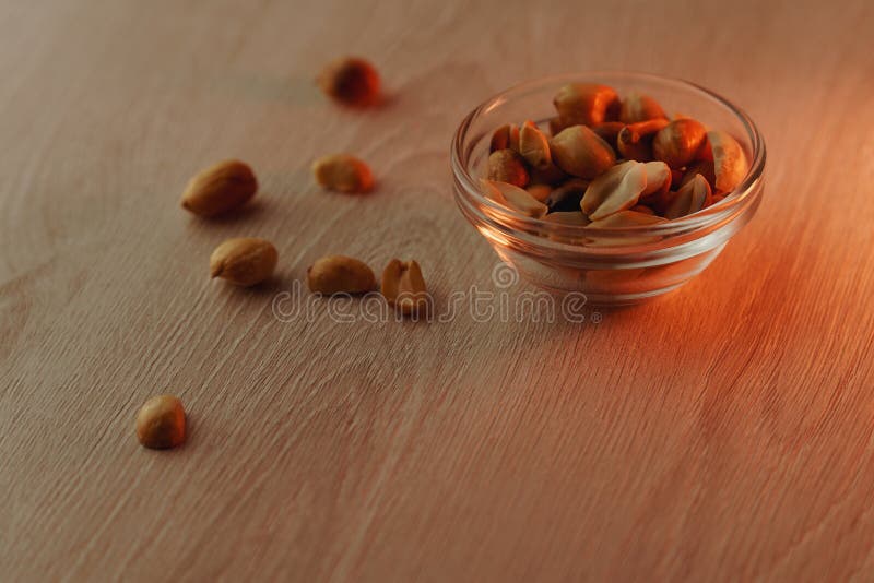 Healthy Snack - Very Small Cup of Peanuts Placed on a Light Wooden ...