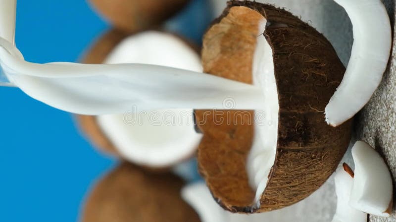 Healthy Vegan Coconut Milk Pouring into Half a Coconut Shell, Splash of ...