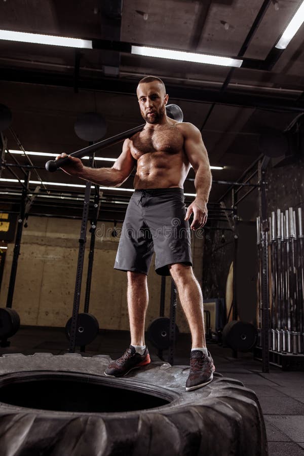 Well-built Guy is Standing on the Wheel and Looking at the Camera Stock ...