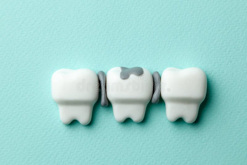 Healthy White Teeth and Tooth with Caries on Green Mint Background ...