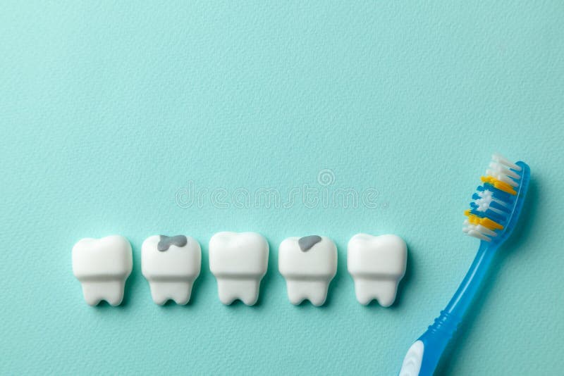 Healthy White Teeth and Tooth with Caries on Green Mint Background and ...