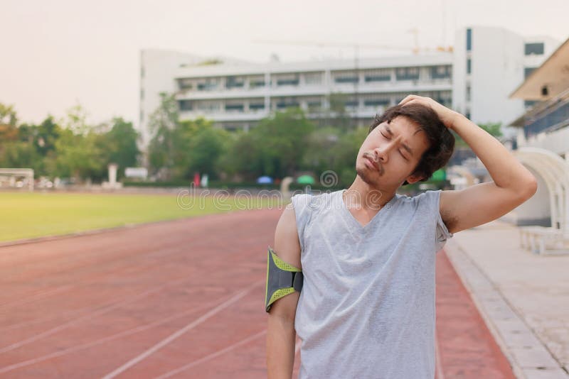 Healthy Young Asian Runner Man Warming Up before Run on Track in the ...