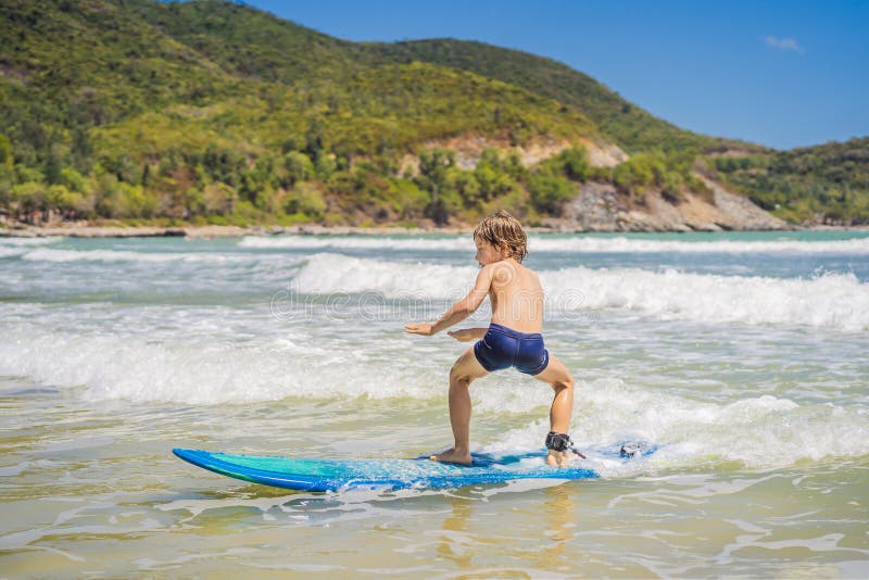 Healthy Young Boy Learning To Surf in the Sea or Ocean Stock Image ...