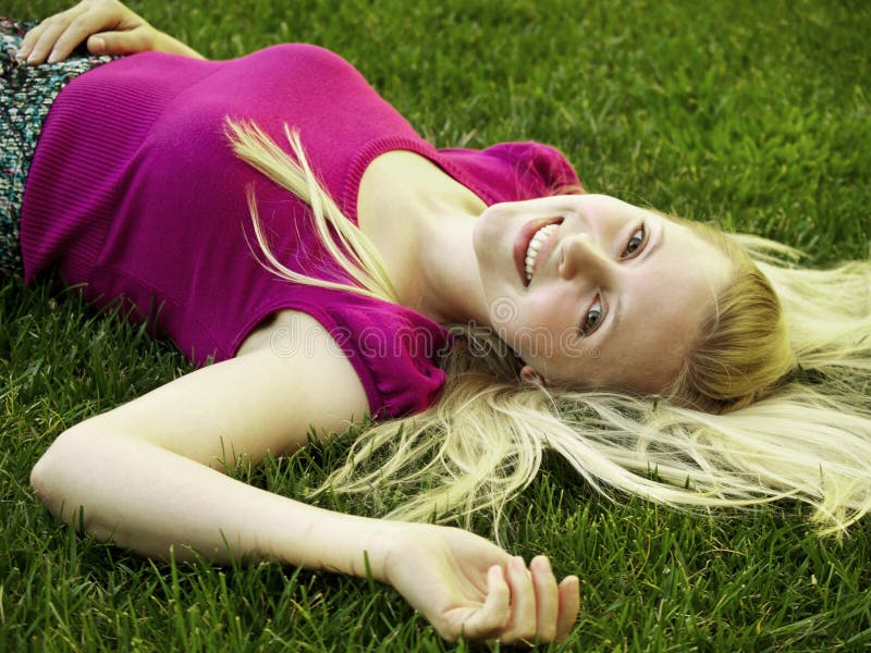 Healthy Young Girl Laying on the Grass Stock Photo - Image of blonde ...