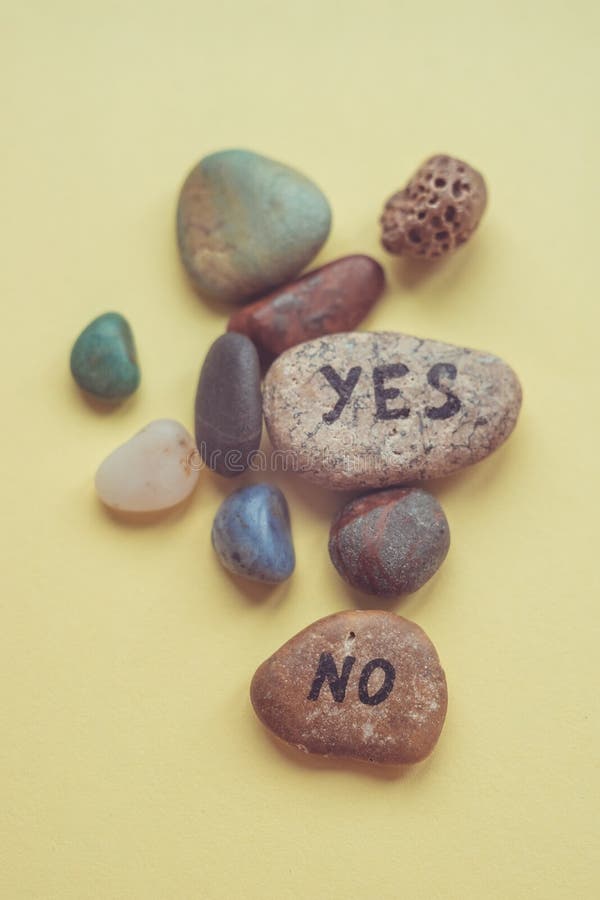 Heap of Clean Pebble Stones and Two with the Text Yes and No on Yellow ...