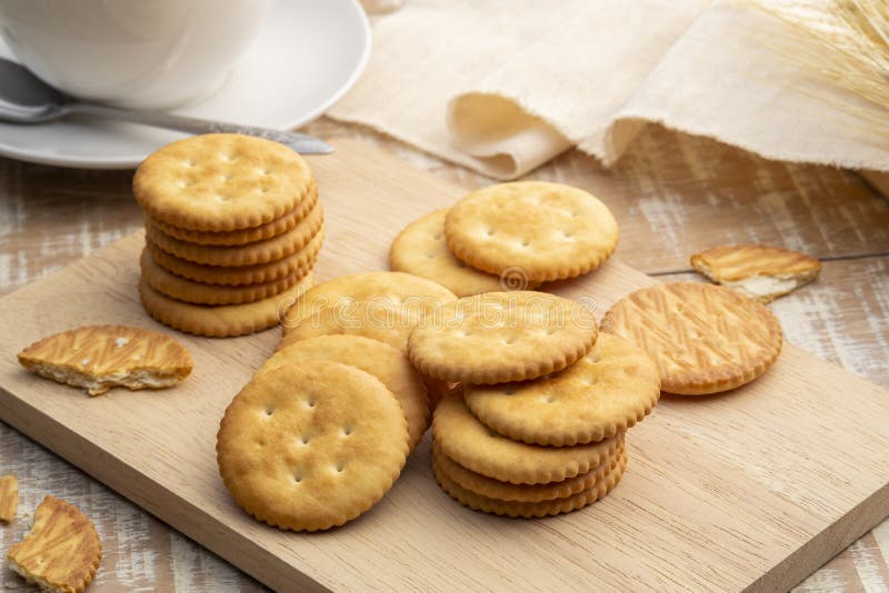 Heap of Dry Thin Crispy Crackers on Cutting Board on Wood Table Stock ...