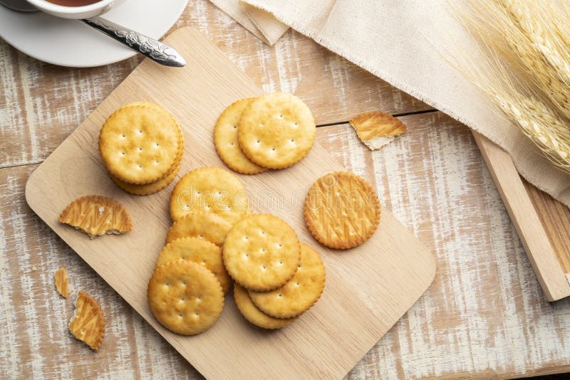 Heap of Dry Thin Crispy Crackers on Cutting Board on Wood Table. Stock ...