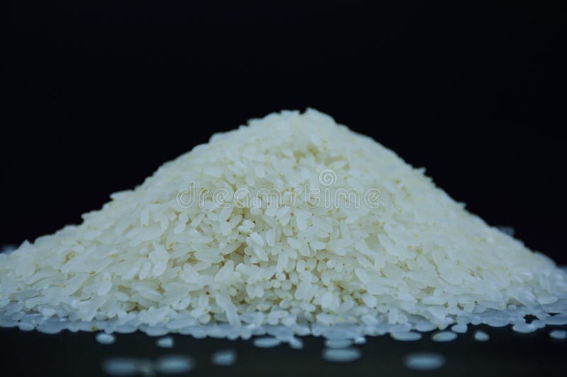 A Heap of Grain Rice on the Black Background Stock Photo - Image of ...