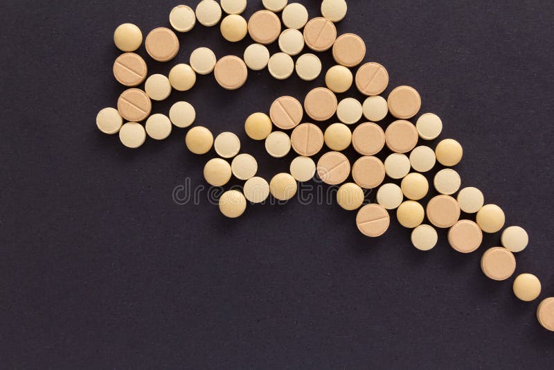 Tablets are on a Black Background. they are Indicated by an Arrow on ...