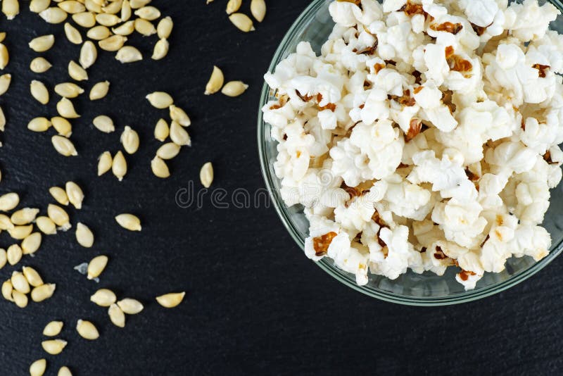 Heap of Raw and Cooked Popcorn Grains on Black Background Stock Photo ...